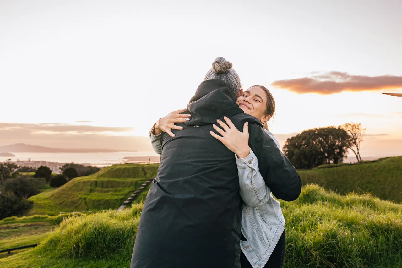 Auckland Brand Library - Man and woman hug on Mount Eden