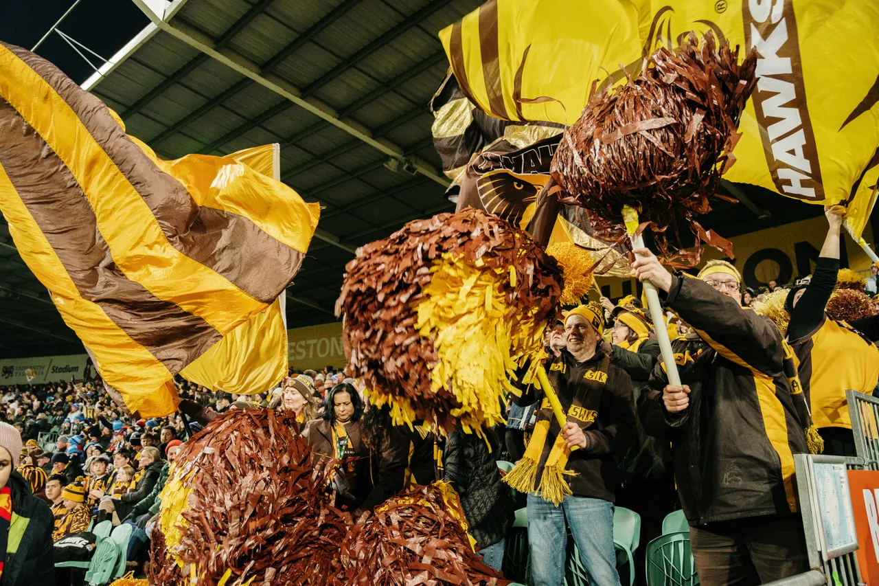 Tasmanian Partner Toolkit - Waving Hawks Flags at UTAS Stadium